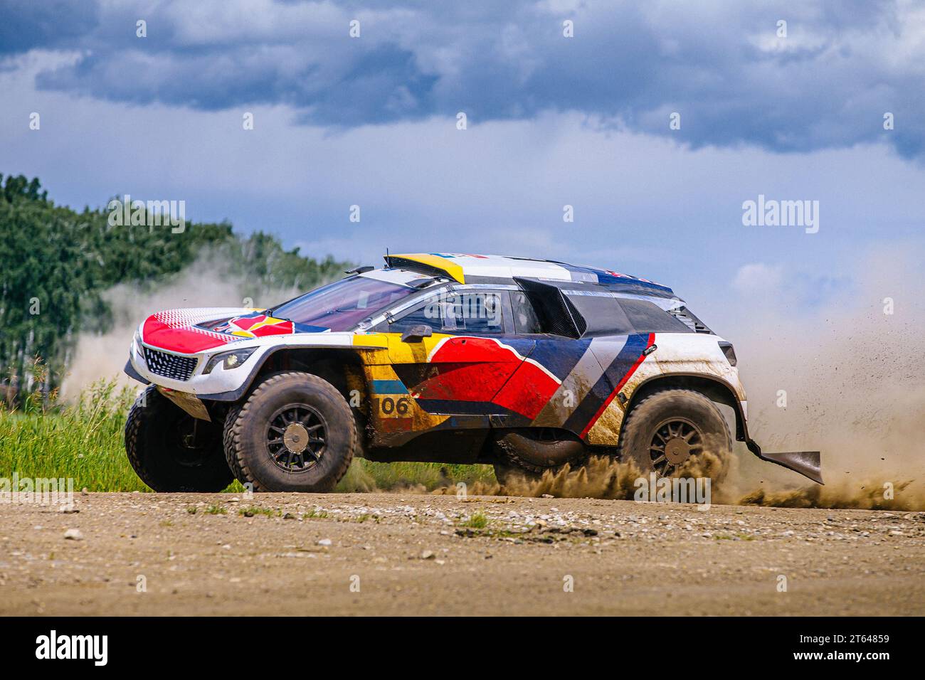 side view racing auto moving on terrain road during cross country rally ...