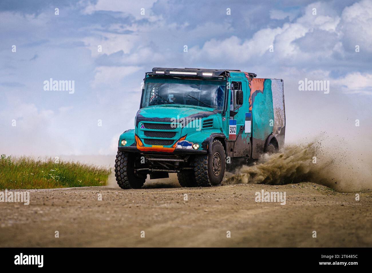 racing truck high speed rides on dusty road during cross country rally ...