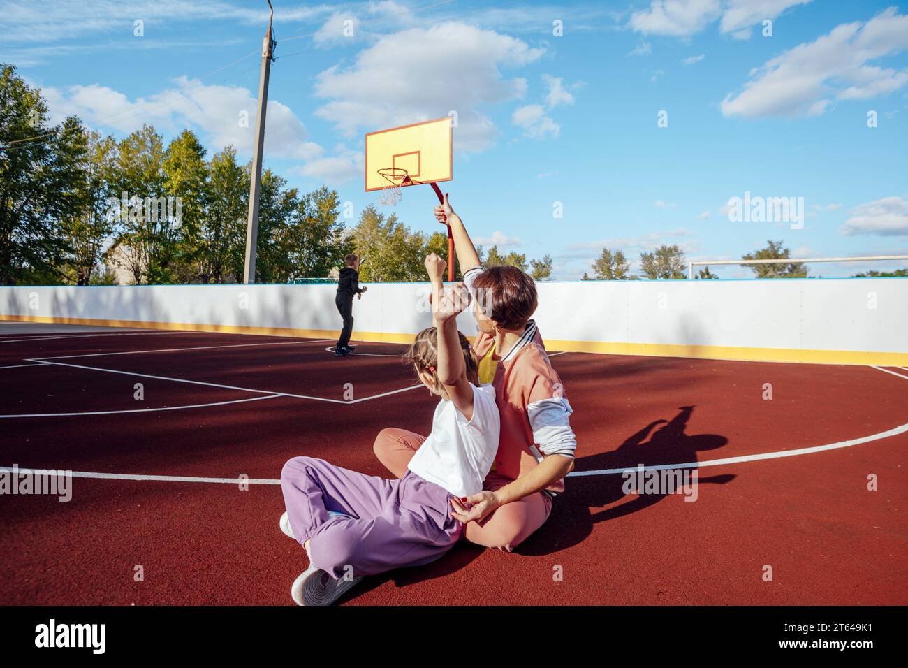 Goal. An emotional woman and a teenage girl cheer for their brother ...