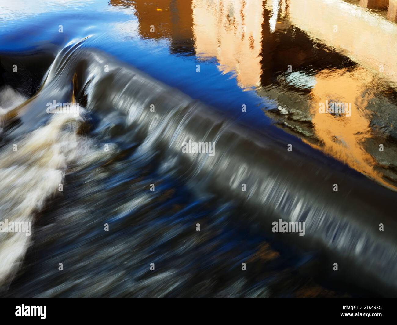 Abstract patterns and reflected modern buildings in the River Aire at ...