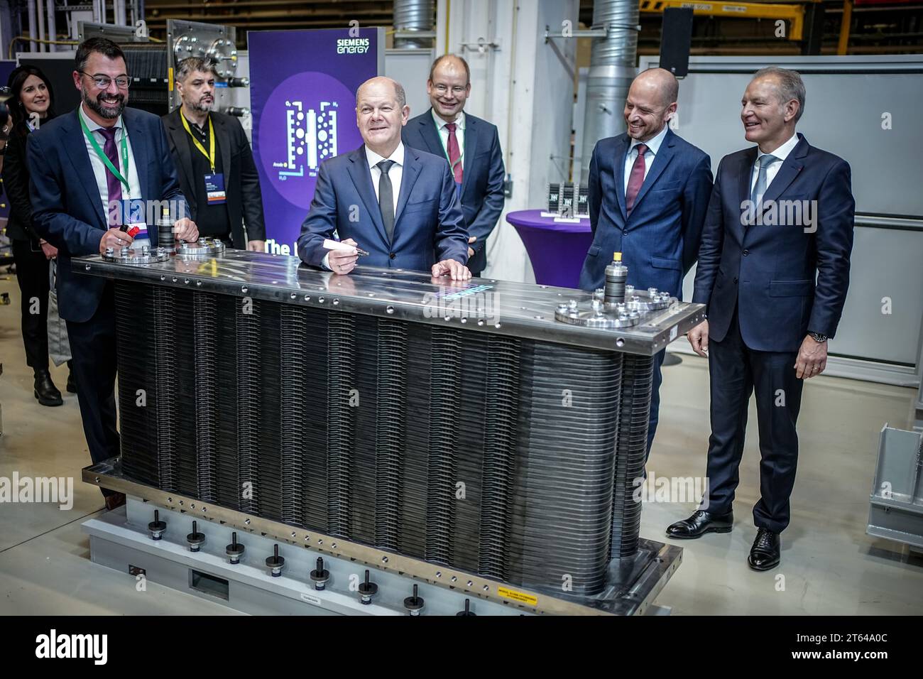 08 November 2023, Berlin: German Chancellor Olaf Scholz (M, SPD) signs alongside Christian Bruch ...