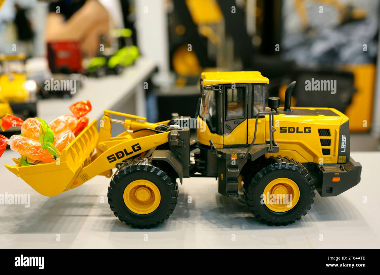 Toy model of a tractor backhoe loader made by SDLG placed on a table ...
