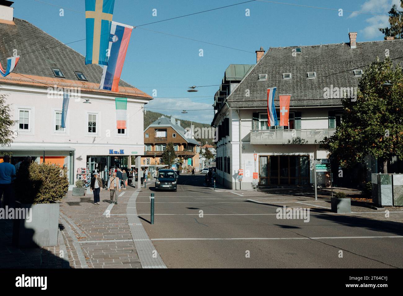 A bustling small town with a diverse population of pedestrians walking ...