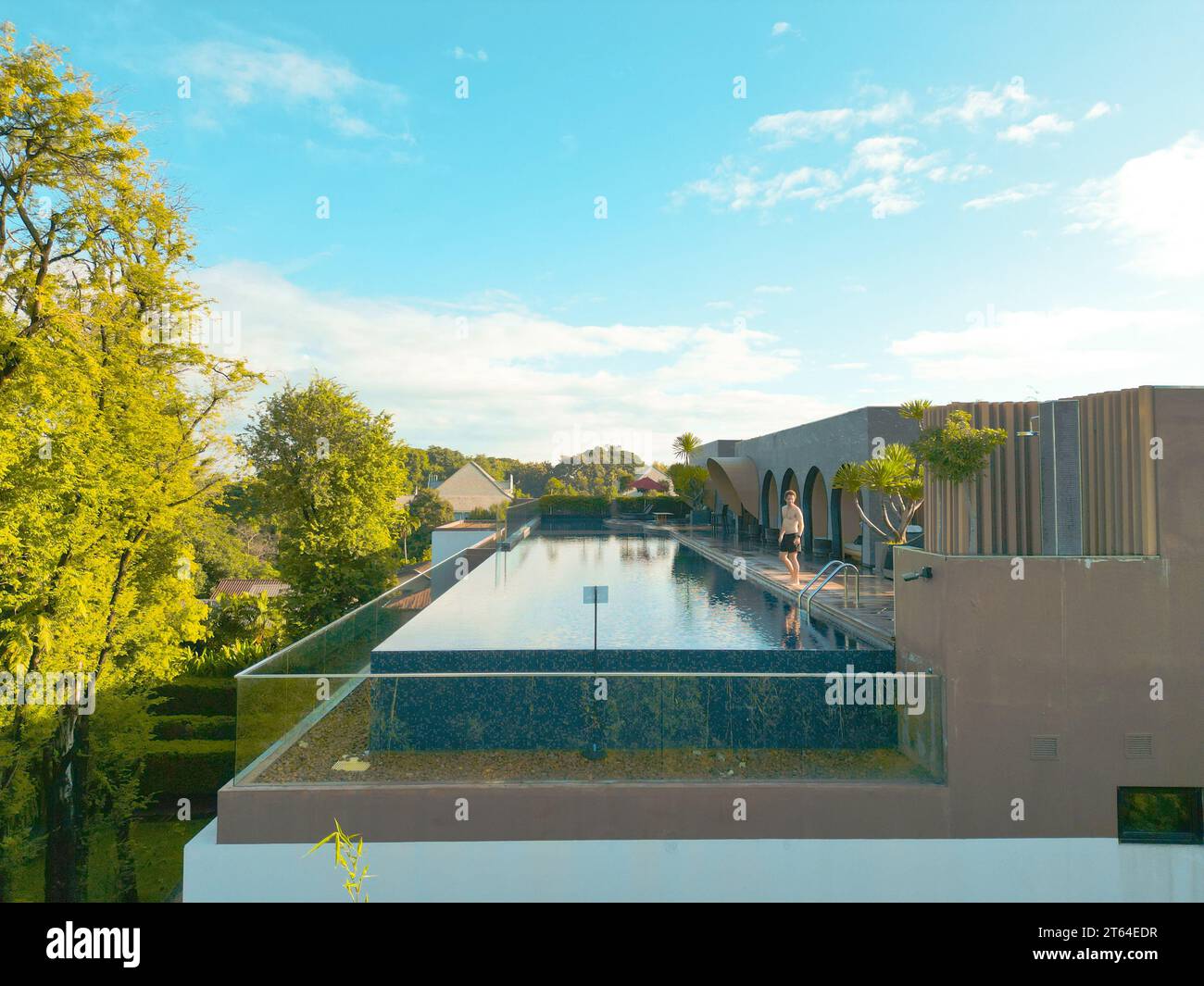 Fit Man Strikes a Pose by the Rooftop Infinity Pool of a Luxury Hotel ...