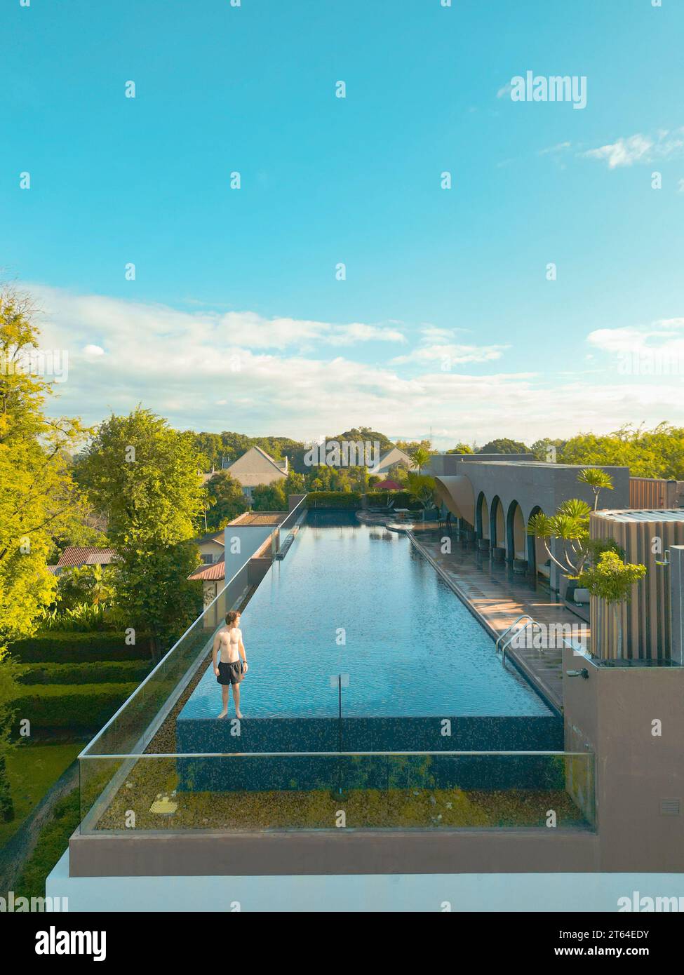 Fit Man Strikes a Pose by the Rooftop Infinity Pool of a Luxury Hotel ...