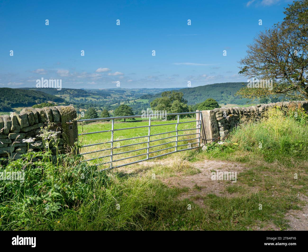 Metal Farm gate and stone wall Stock Photo - Alamy
