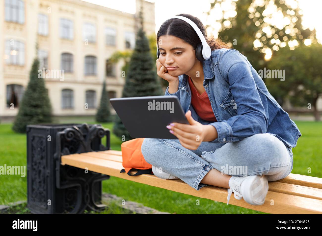 Tired unhappy pretty young indian woman student looking at tablet Stock ...