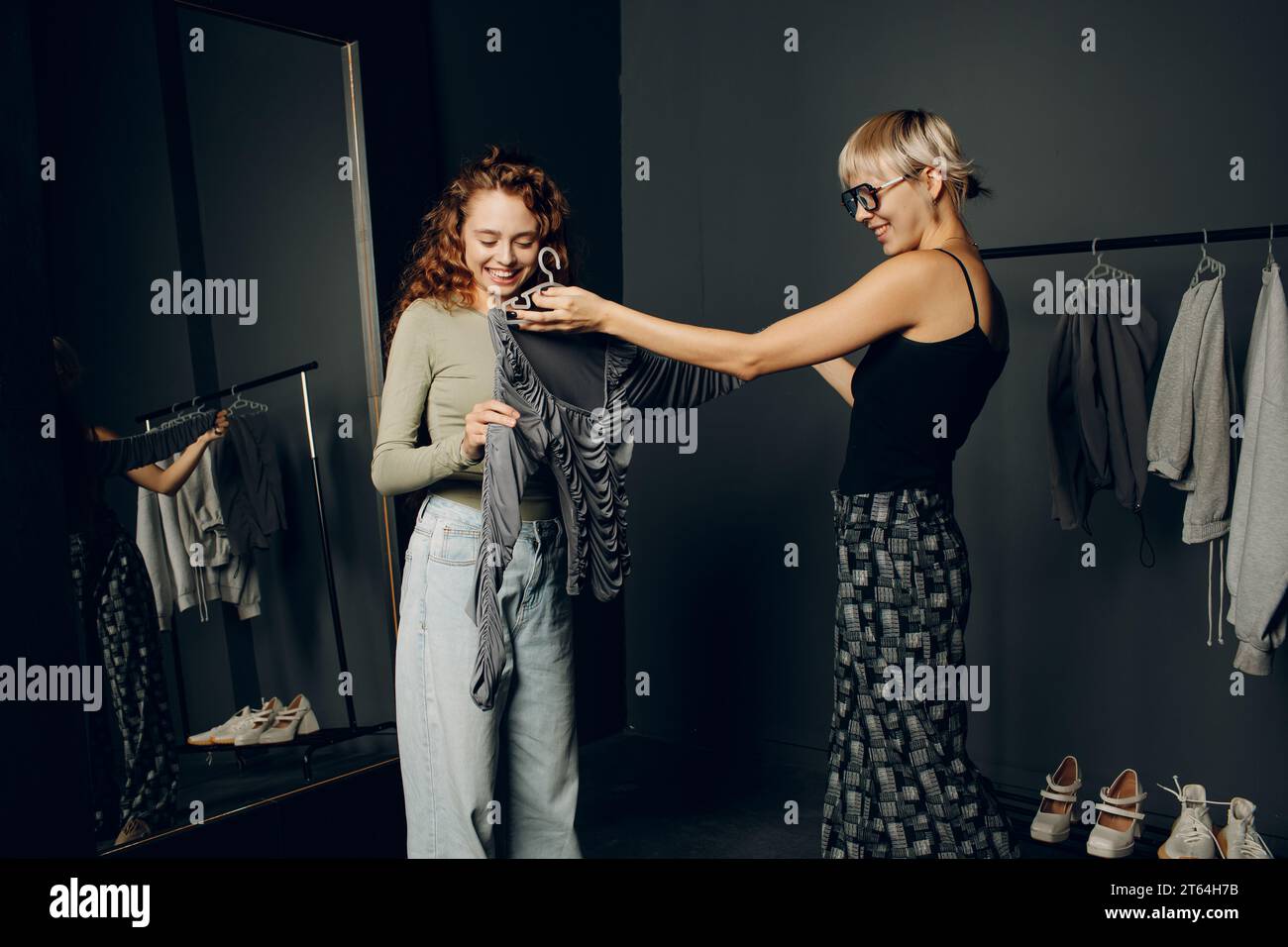 Stylist designer helping choose clothes dress to customer client Stock ...