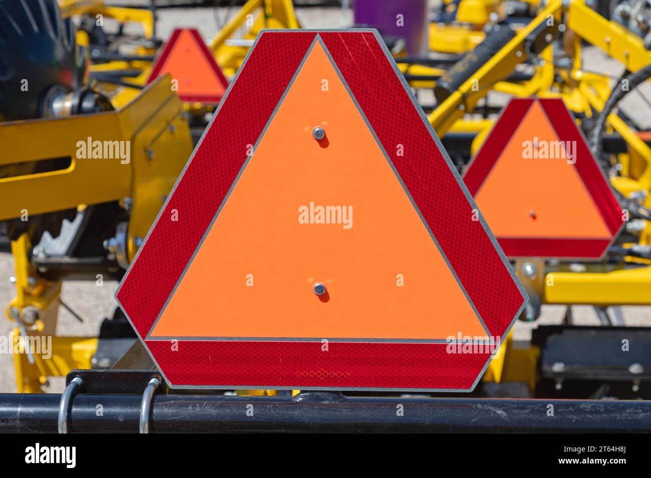 Red Reflective Triangle Sign at Agriculture Trailer Stock Photo - Alamy