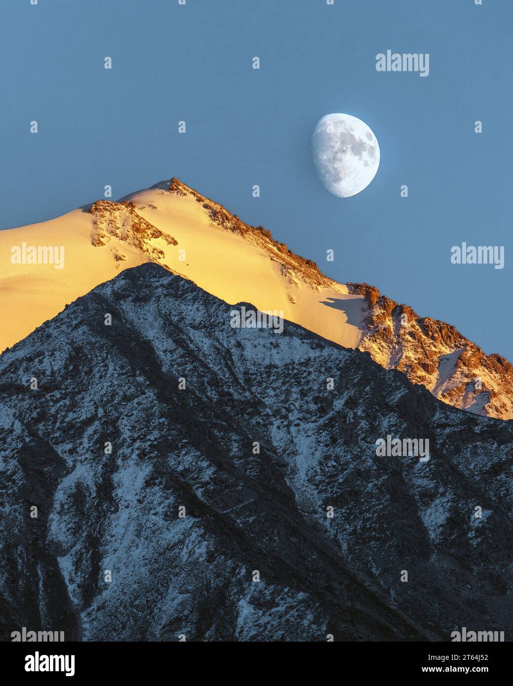 Mountain landscape with an almost full moon and sunset with Soviet Peak ...