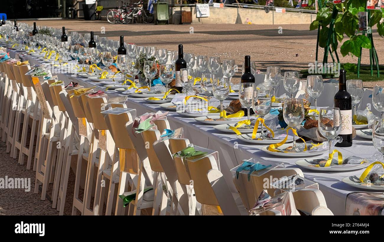 An art installation of "empty beds" and a "hostage table" in front of ...