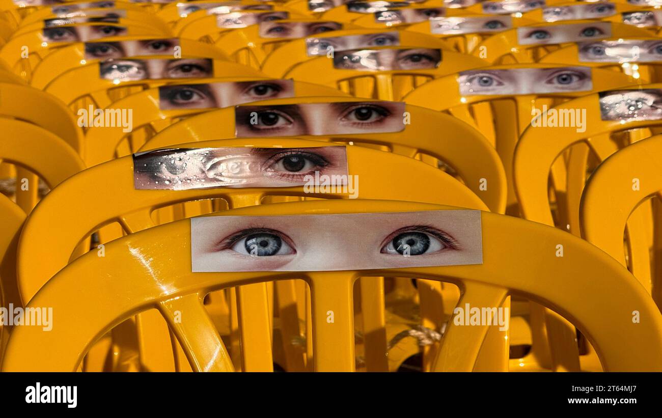 An art installation of "empty beds" and a "hostage table" in front of ...