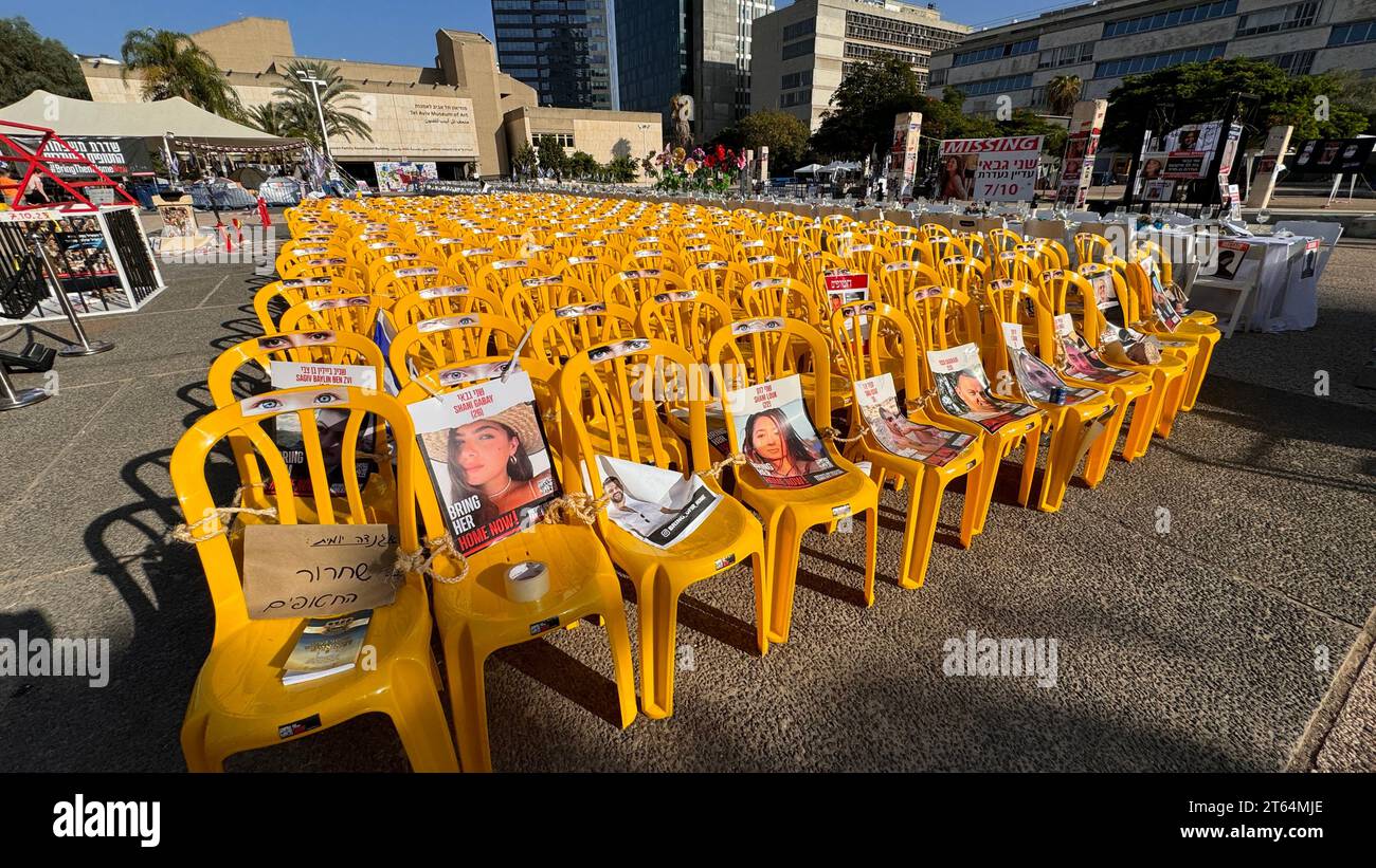 An art installation of "empty beds" and a "hostage table" in front of ...