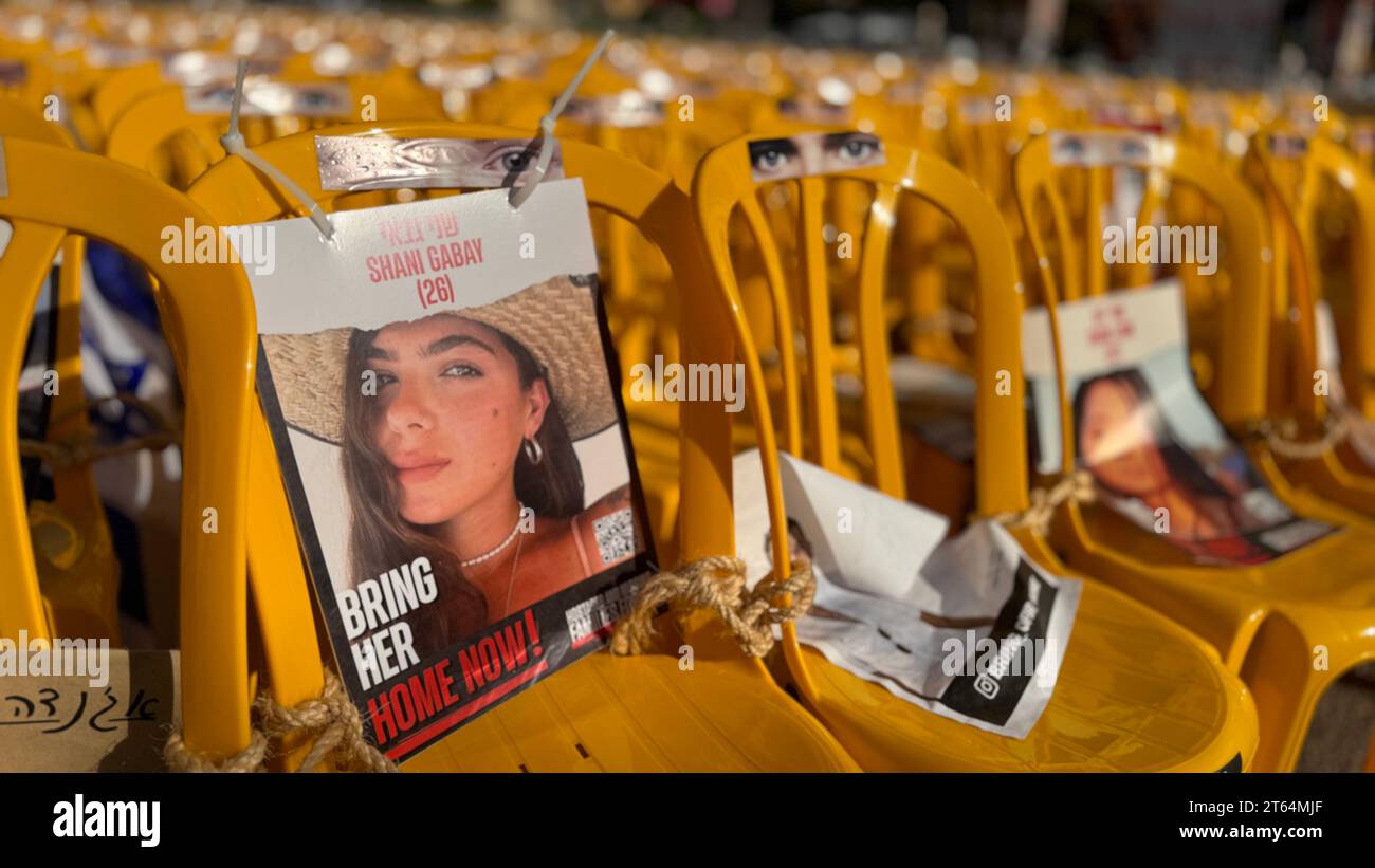 An art installation of "empty beds" and a "hostage table" in front of ...
