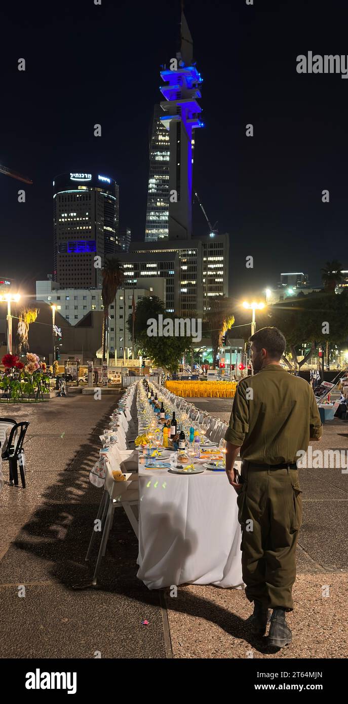 An art installation of "empty beds" and a "hostage table" in front of ...