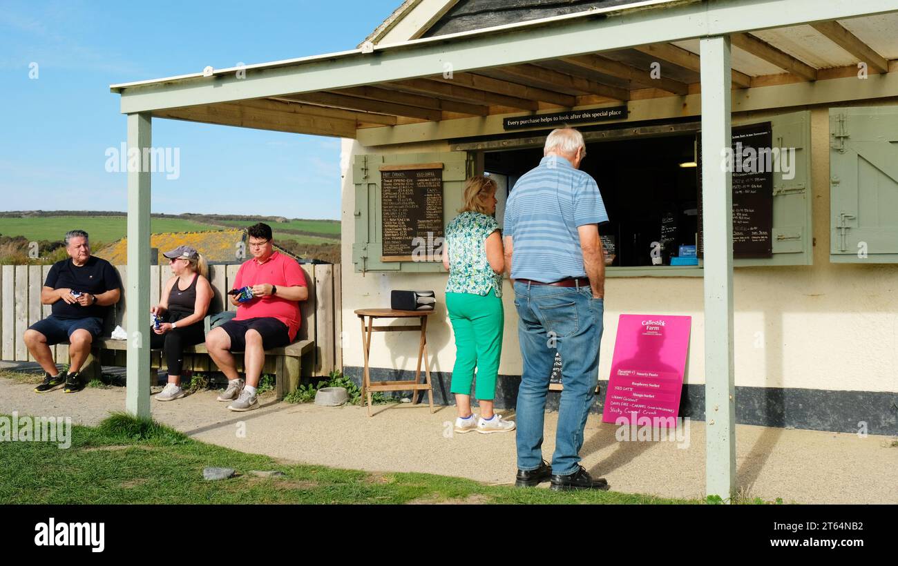 Holiday makers buying refreshments at a National Trust cafe, Gunwalloe ...