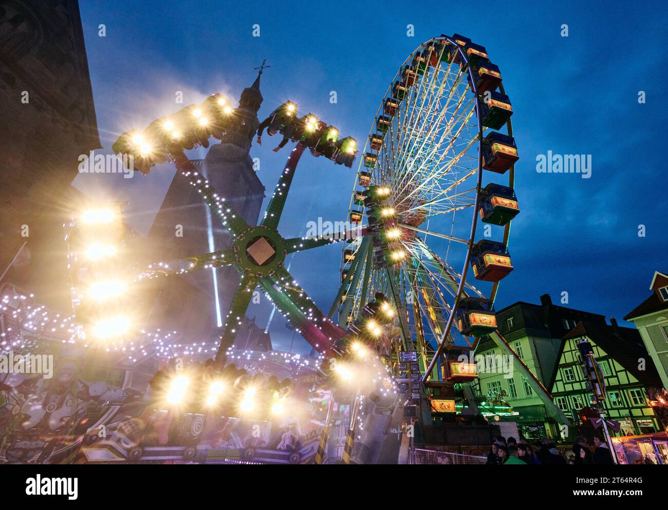 Soest, Germany. 08th Nov, 2023. Two fairground rides rotate at the All ...