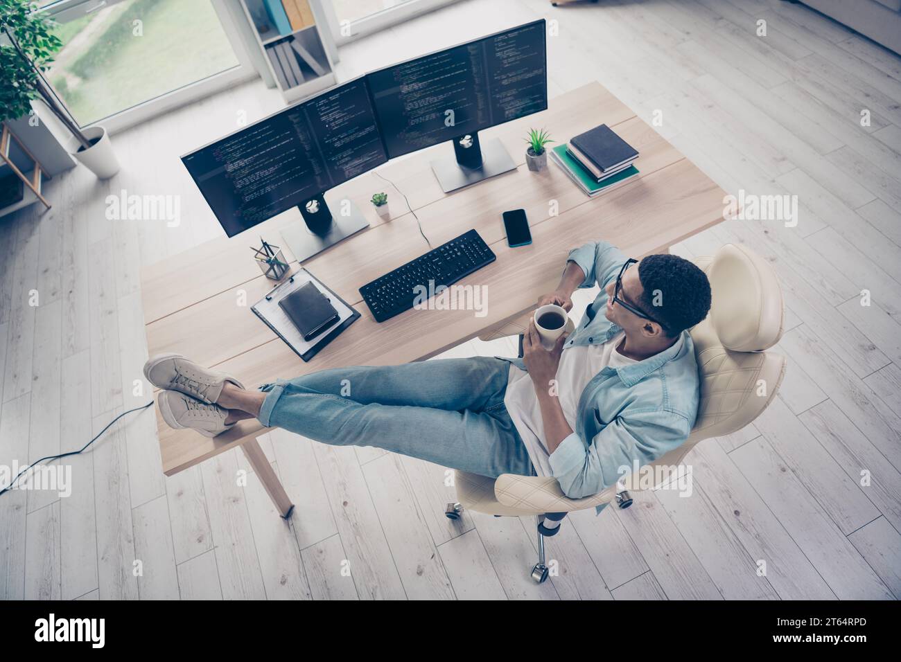 Upper view photo of relaxing professional programmer guy lying armchair ...