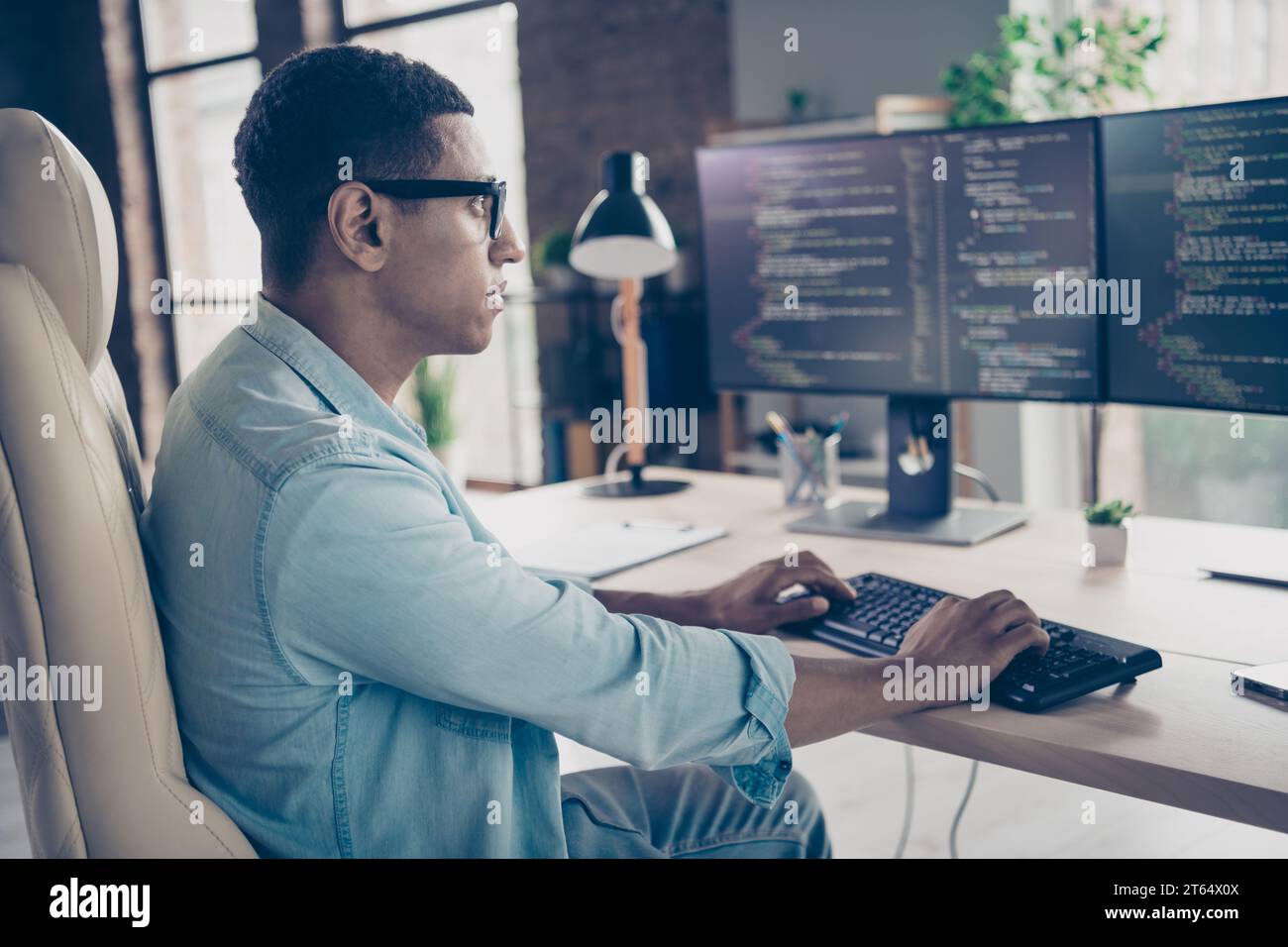 Photo of young man skilled web developer it specialist fixing bugs in his code cyber security ...
