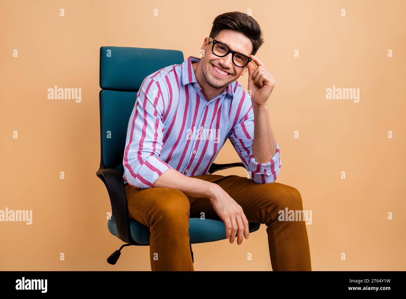 Photo of nice cheerful man wear trendy clothes sitting chair holding ...