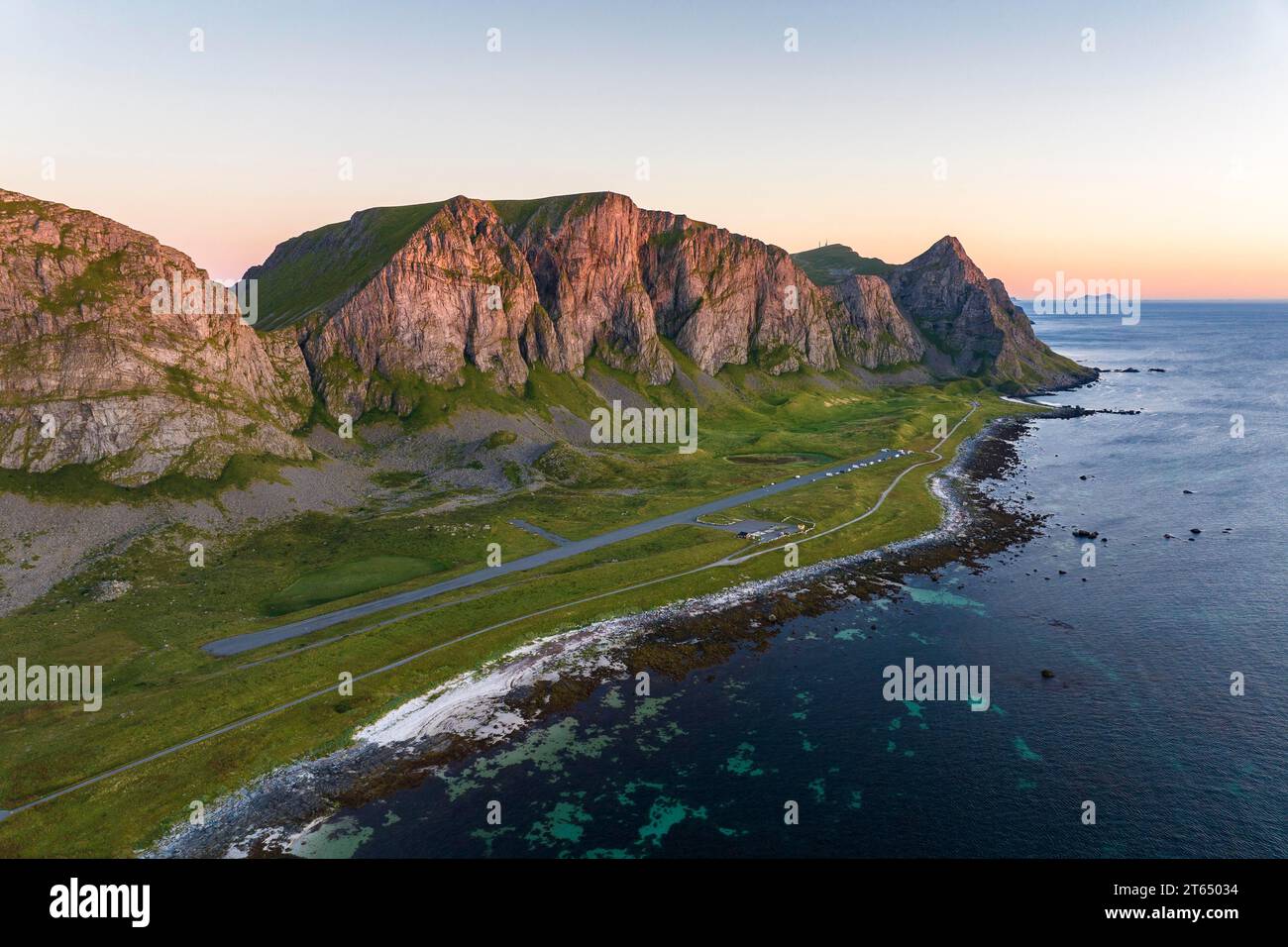 Coast and mountains in the evening light, runway of the abandoned ...