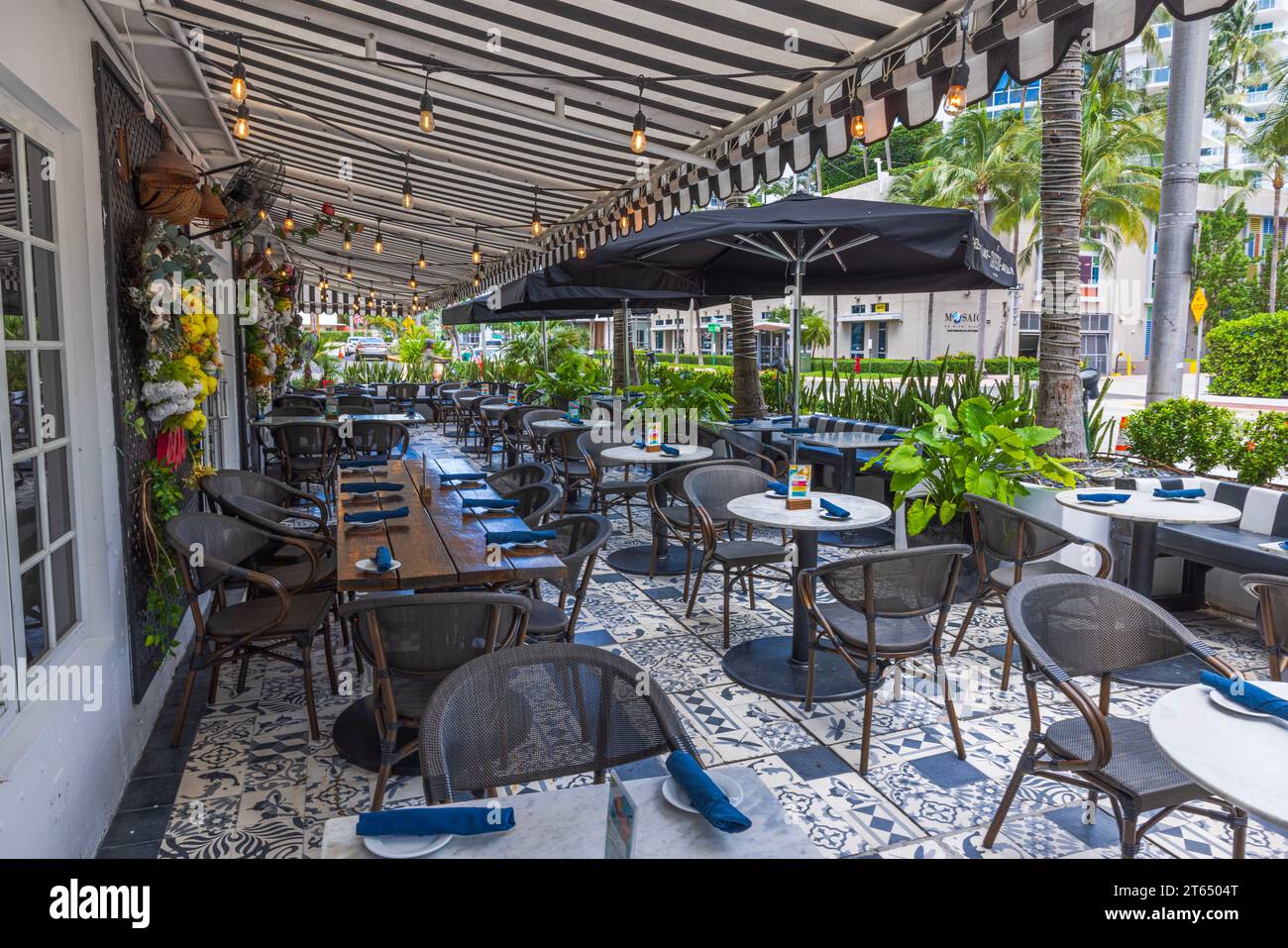 Glimpse of inviting city restaurant's exterior with elegantly set ...