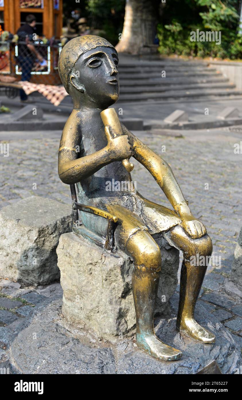 Bronze replica of an antique statue of a traditional table master, or ...