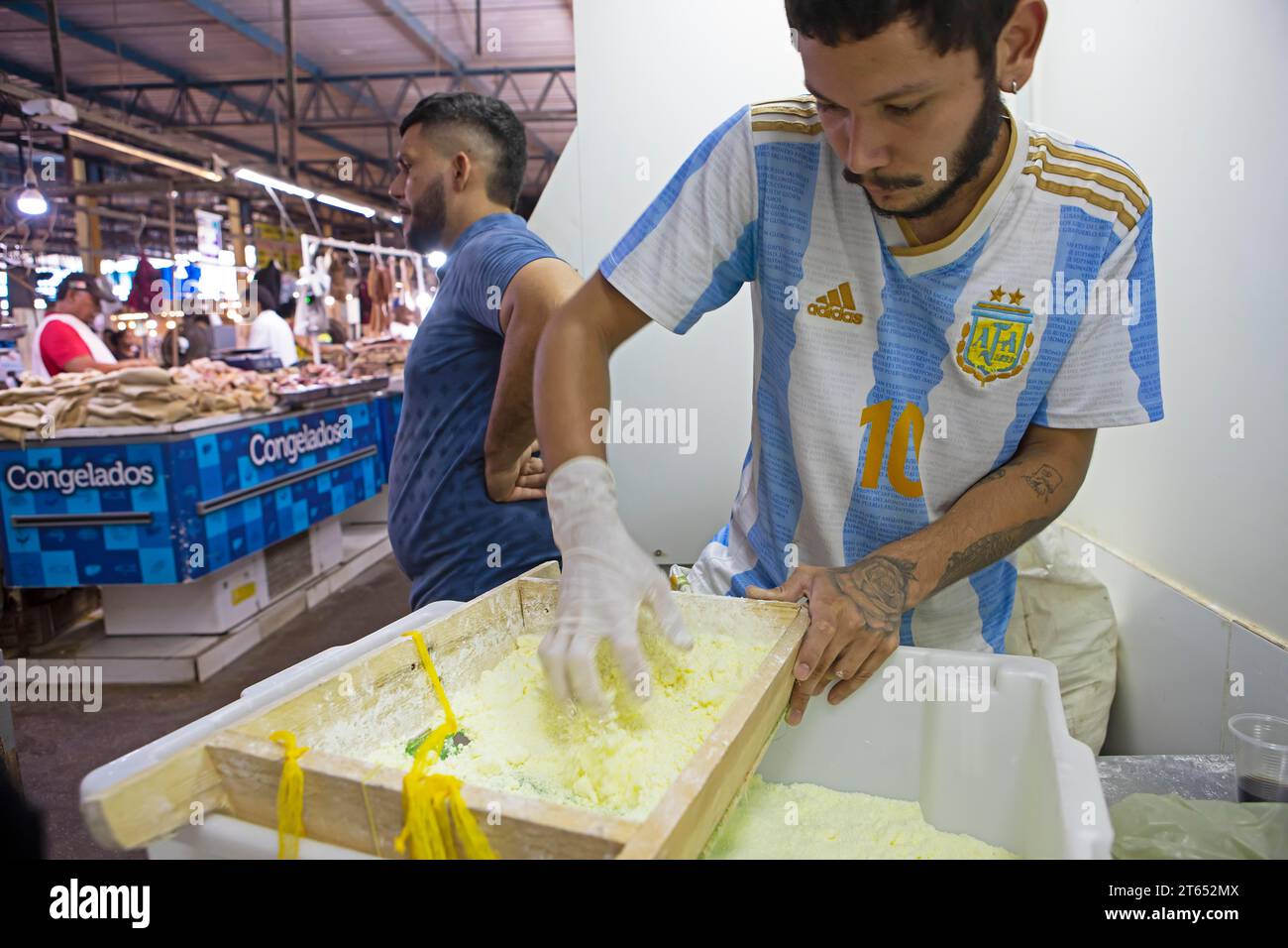 Brazilian man kneading starch from manioc or goma powder, Adolpho ...