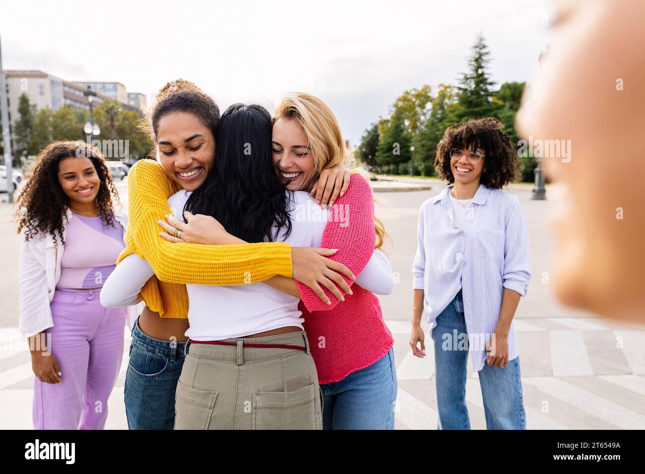 Happy Multiracial Women Meeting Together At City Street Hugging Each
