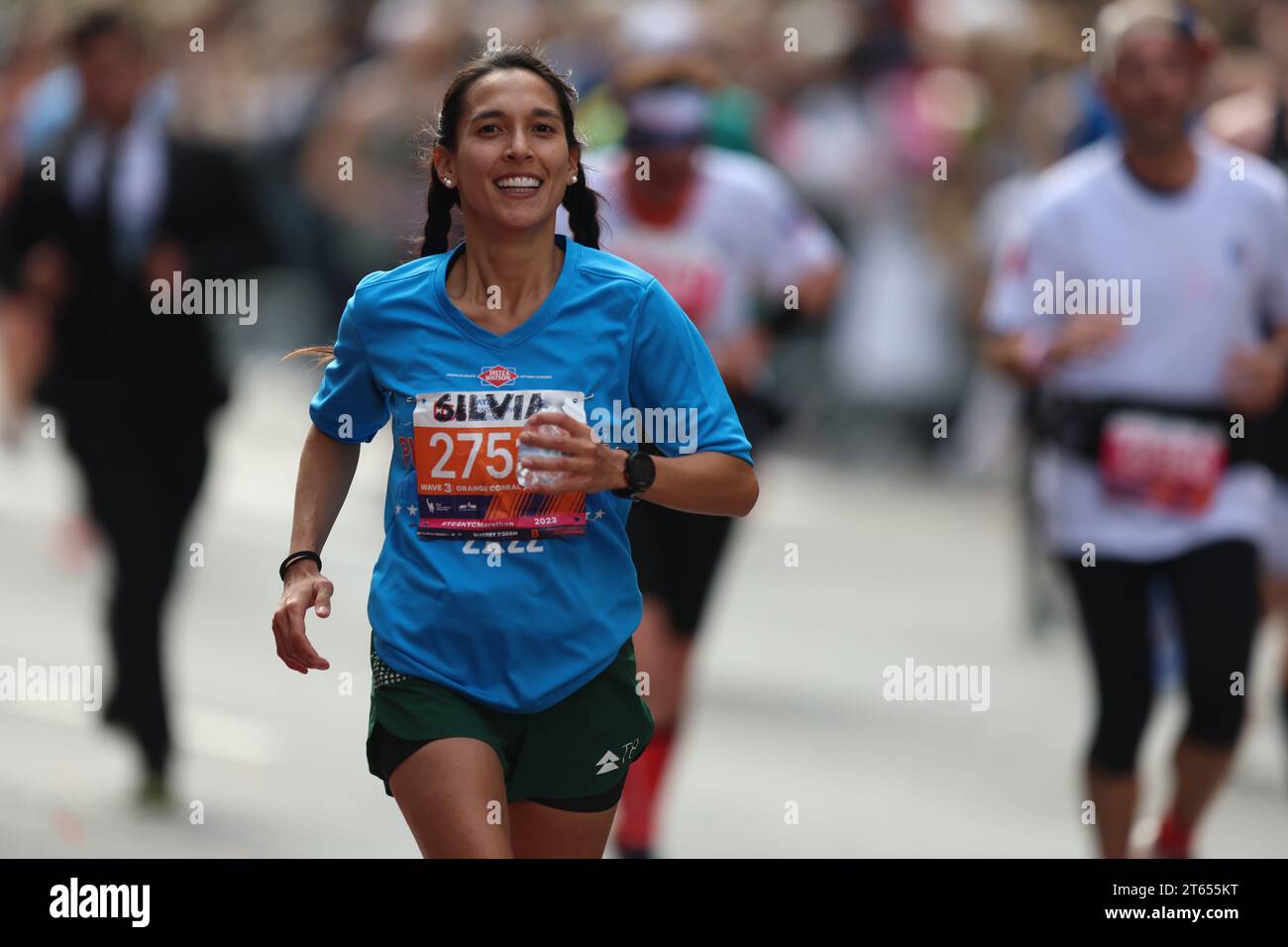 Silvia Alves Nishioka of New York City looks very happy as she passes ...