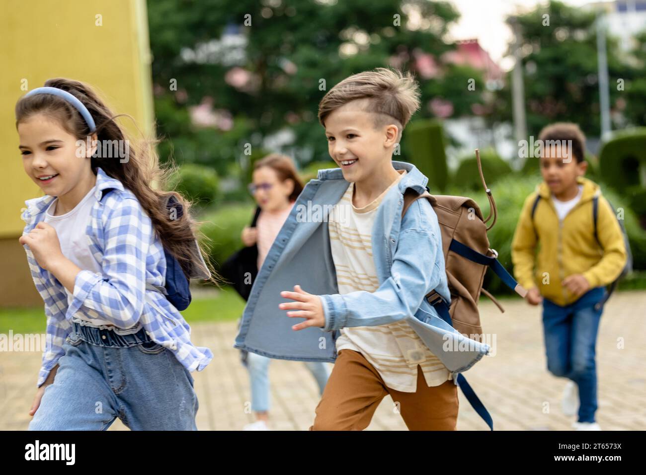 Happy kids running at the school yard Stock Photo - Alamy