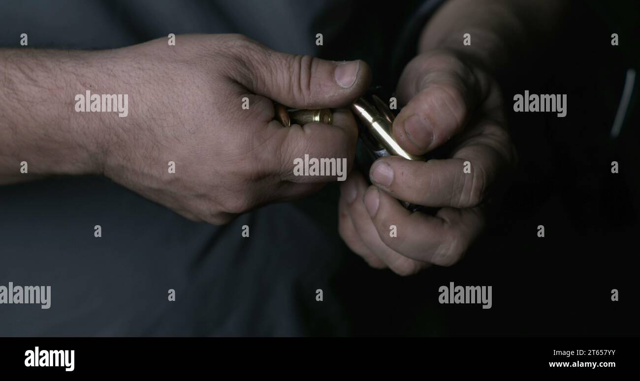Close-up hand Reloading ammunition. Bullets into clip Stock Photo - Alamy