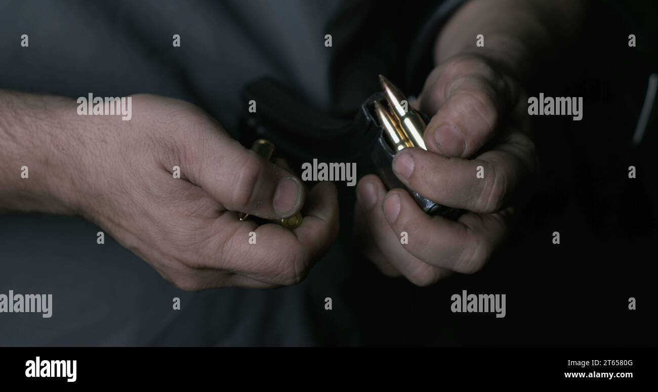 Close-up hand Reloading ammunition. Bullets into clip Stock Photo - Alamy