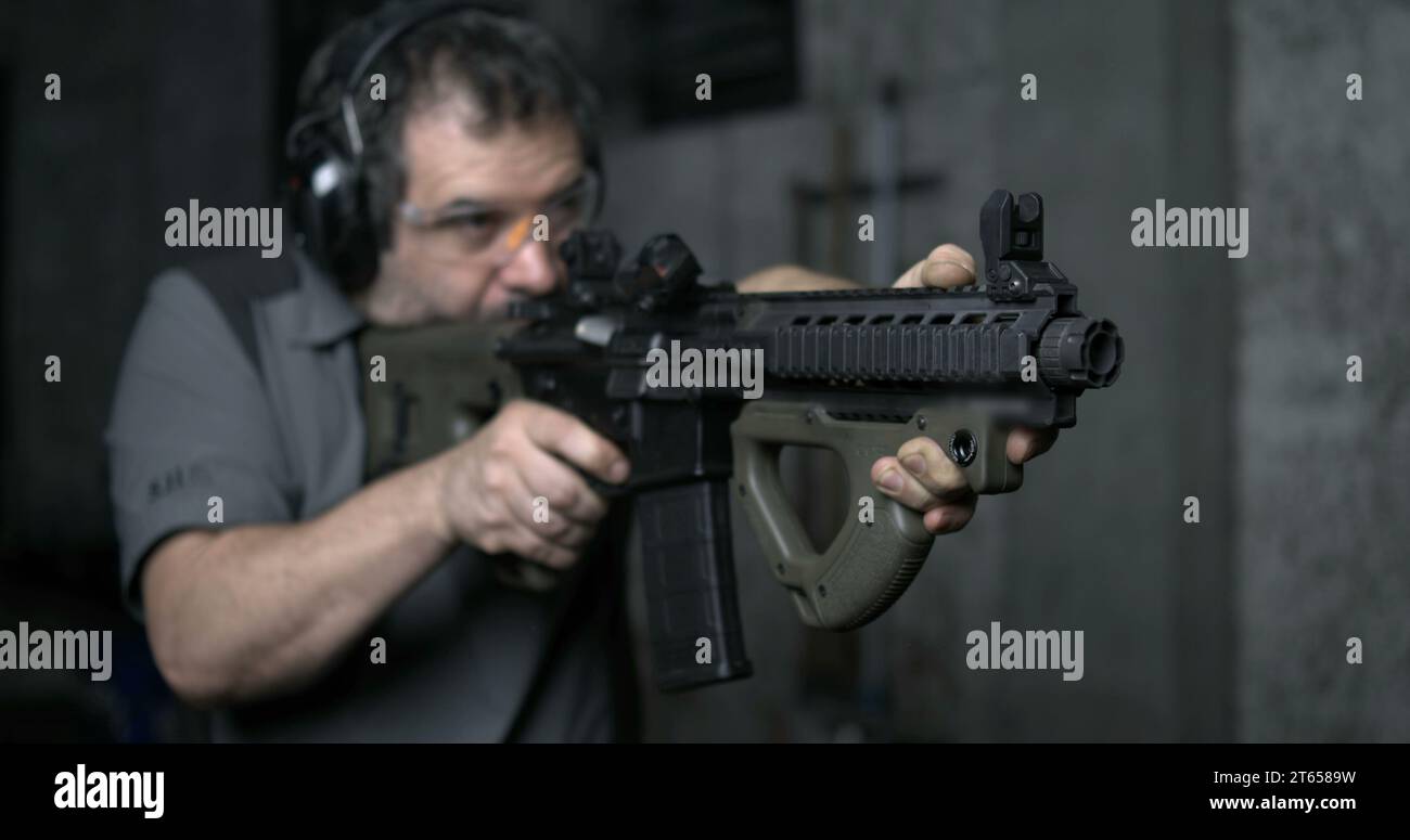 Man aiming and firing an assault rifle in high-speed 800 fps. Shooting ...