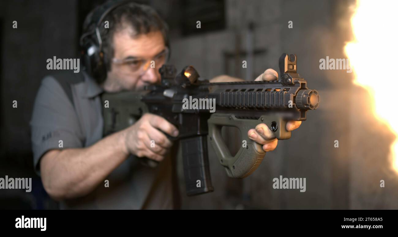 Man aiming and firing an assault rifle in high-speed 800 fps. Shooting ...