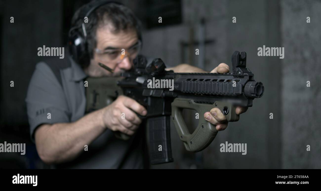 Man aiming and firing an assault rifle in high-speed 800 fps. Shooting ...