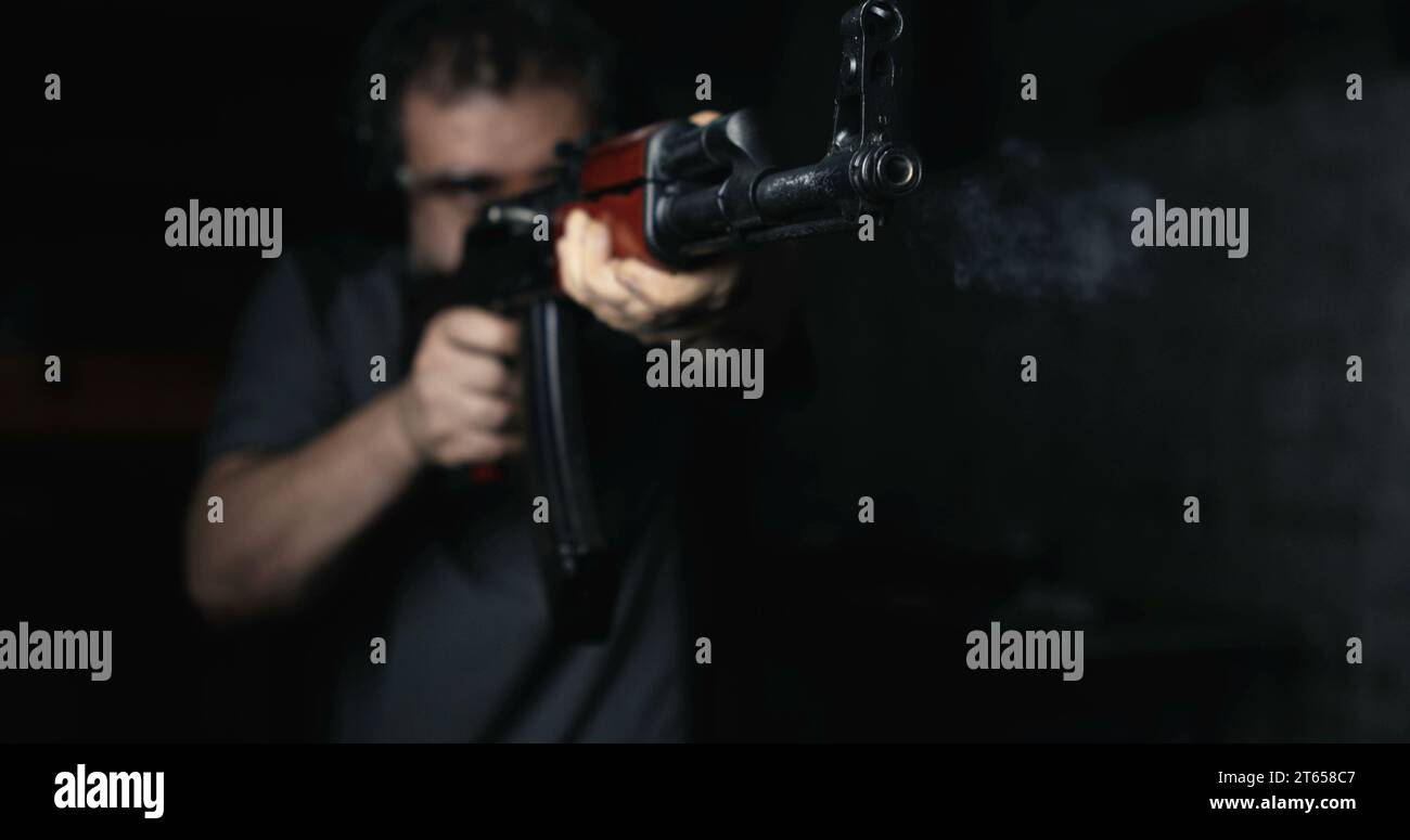 Man aiming with Kalashnikov Weapon firing in super slow-motion at high ...