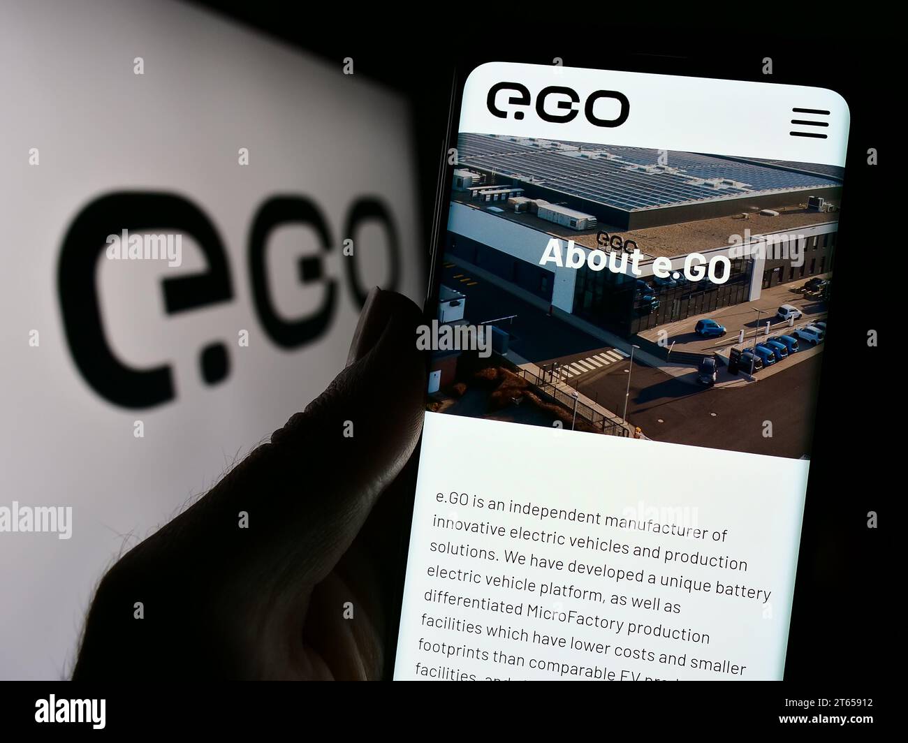 Person holding smartphone with website of German electric vehicle ...