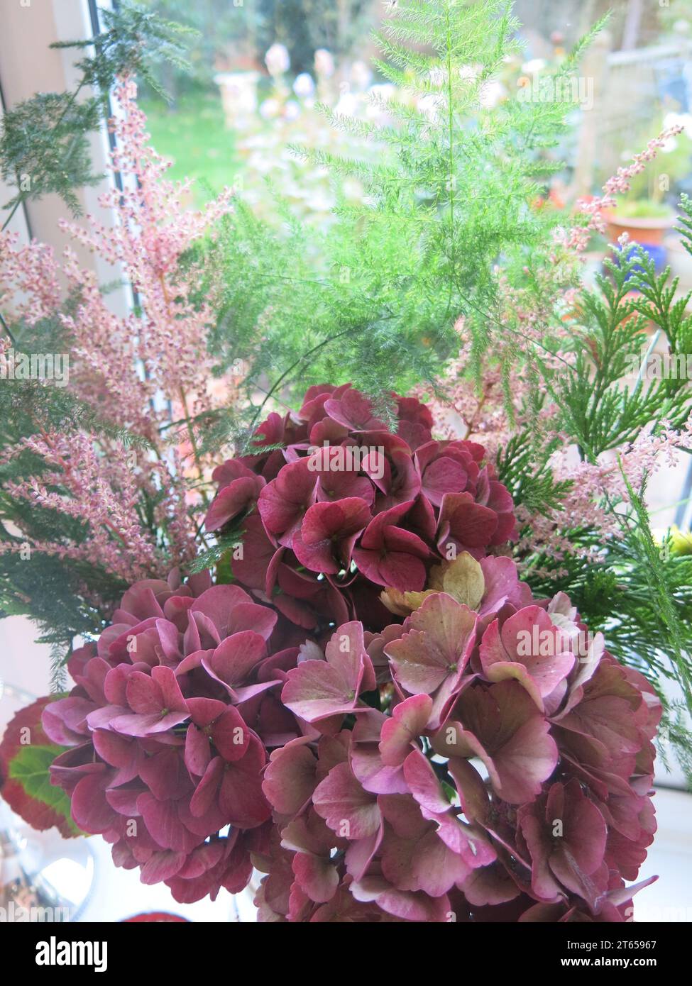 Autumn floral display for the windowsill: a vase filled with the large ...