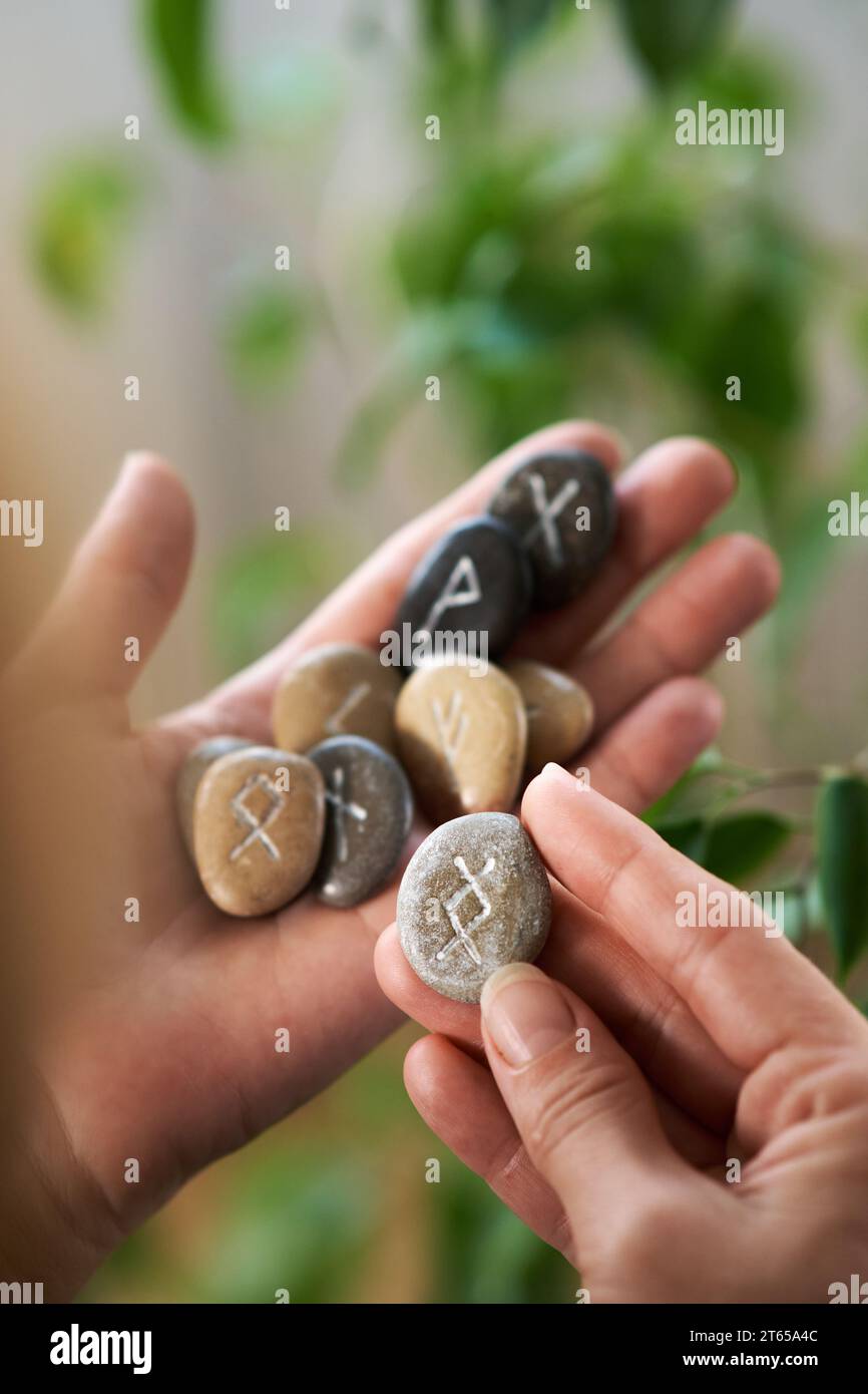 stone runes in a woman's hand Stock Photo - Alamy