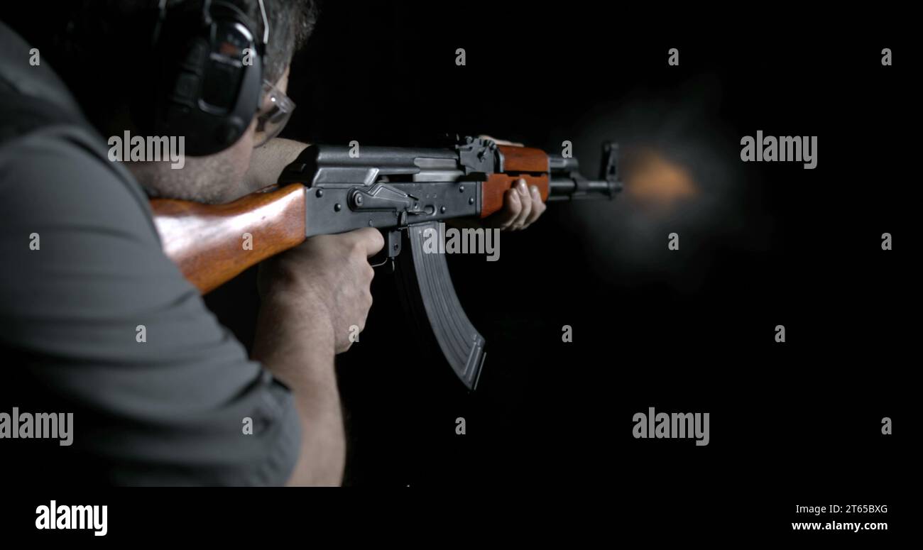 Shooting Kalashnikov weapon at highs-speed 800 fps slow-motion. Person ...