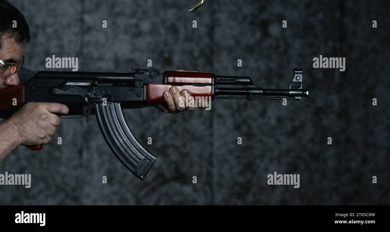 Side view of person shooting an AK-47 Rifle in high-speed 800 fps. Slow ...