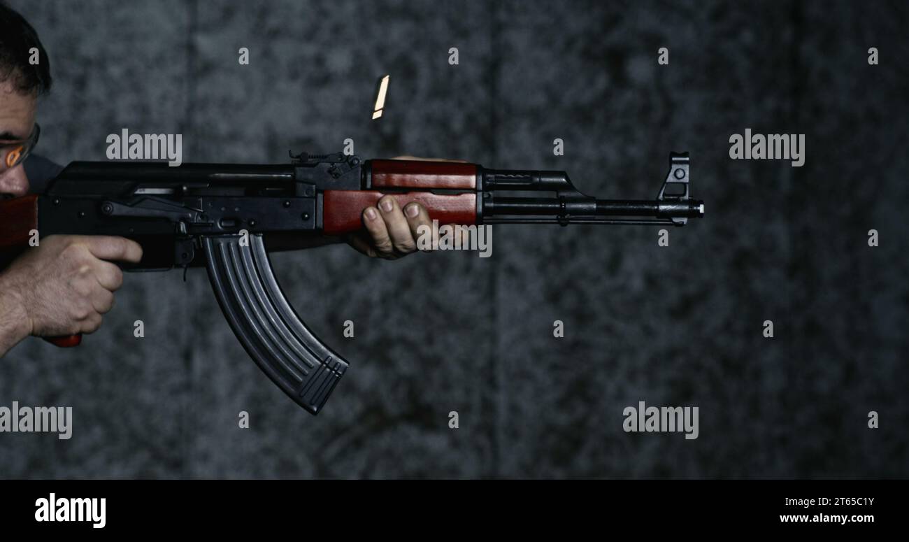 Side view of person shooting an AK-47 Rifle in high-speed 800 fps. Slow ...