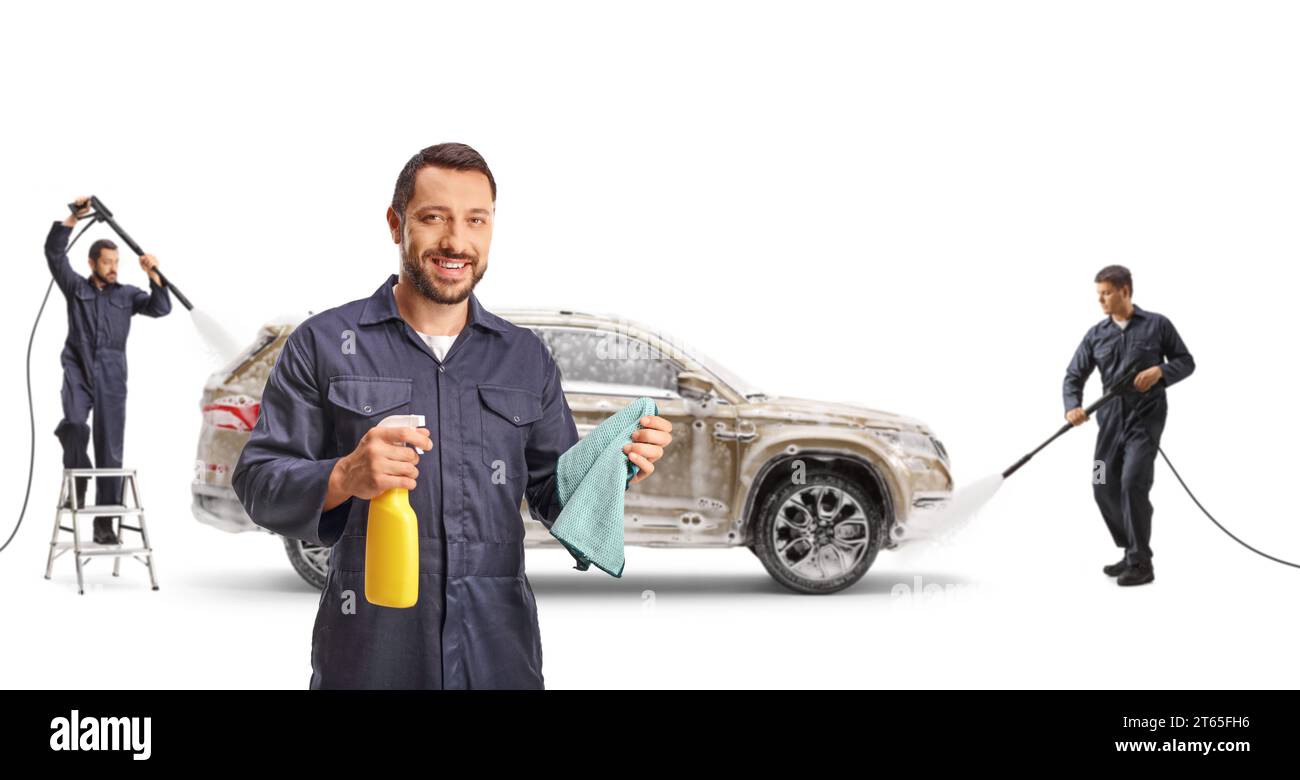 Vehicle at the car wash, worker holding a cloth and men washing a SUV ...