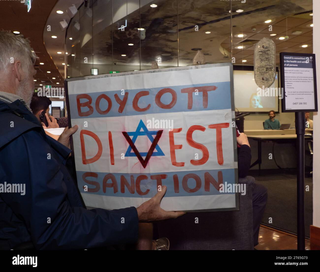 A protester holds a placard expressing opinion during the rally. Merri ...