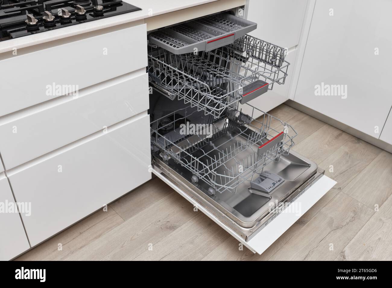 Modern built-in empty dishwasher with open door in the kitchen Stock ...