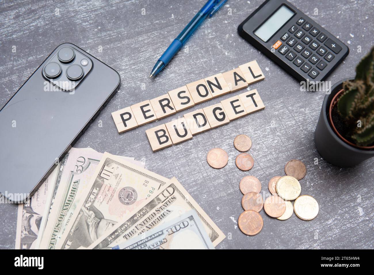 Flat lay photo showing the words personal budget next to money, a ...