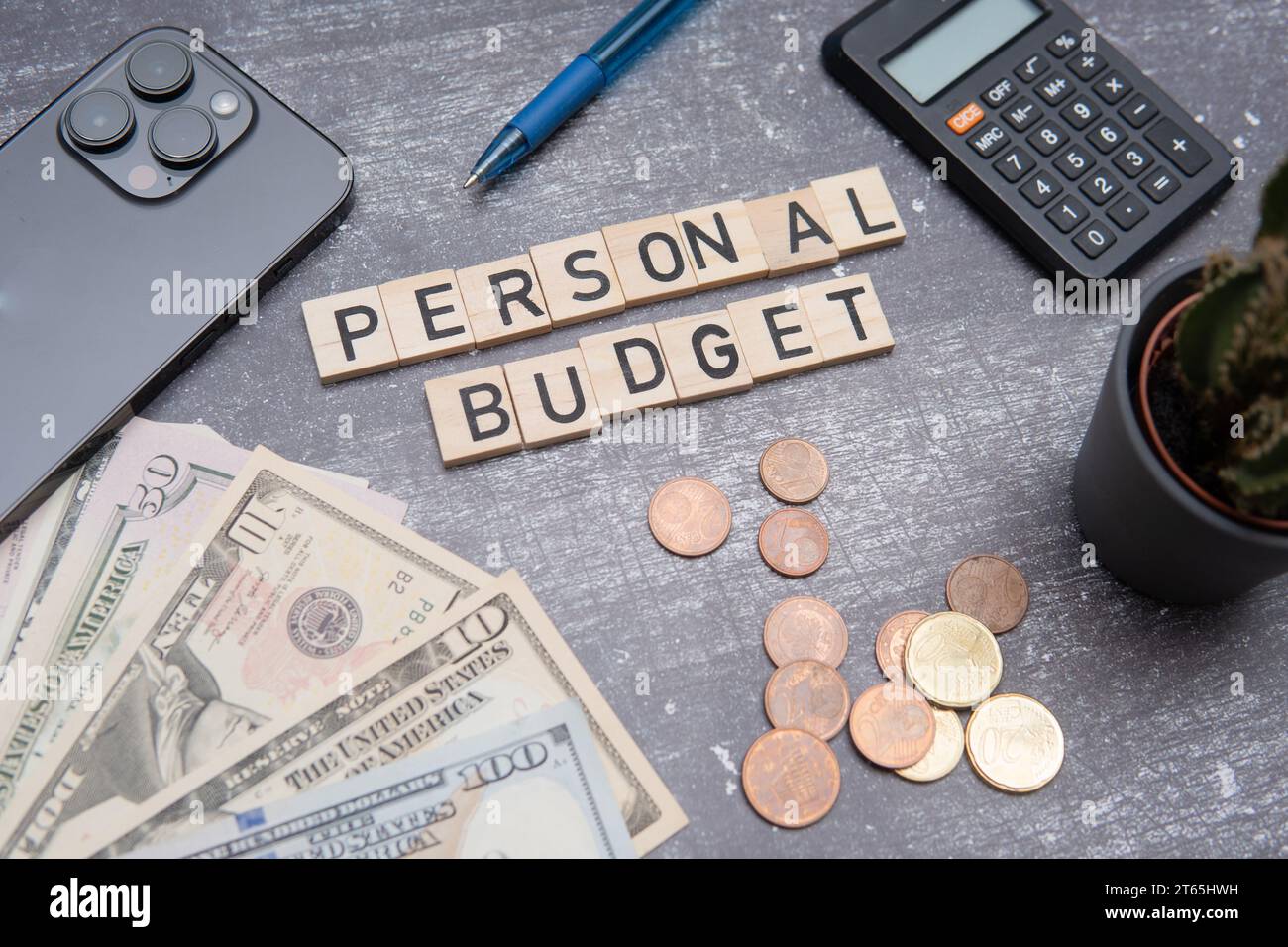 Flat lay photo showing the words personal budget next to money, a ...