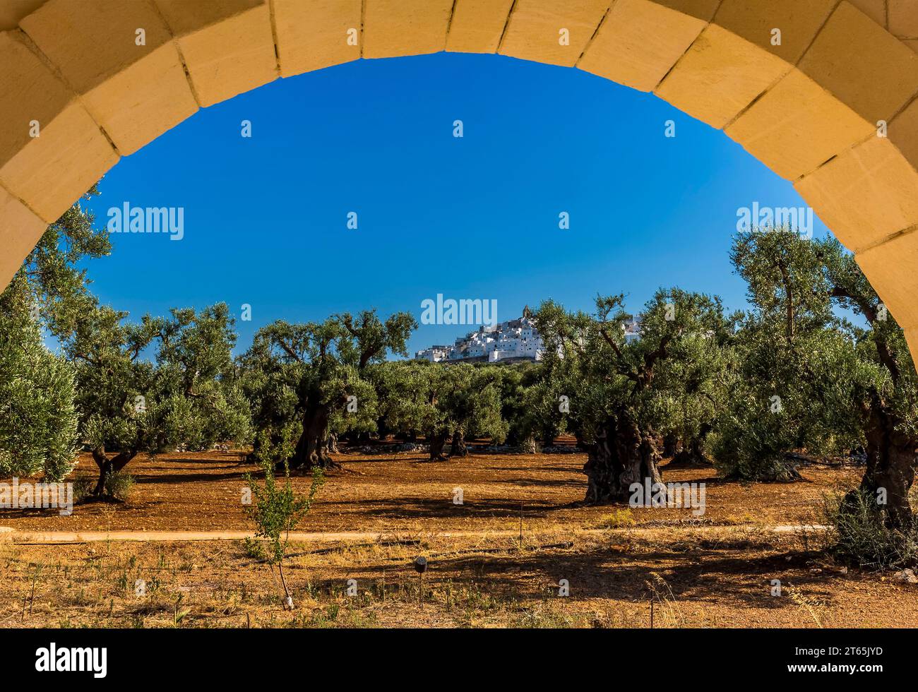 Distant view of Ostuni, Puglia, Italy framed by farmhouse balcony and ...