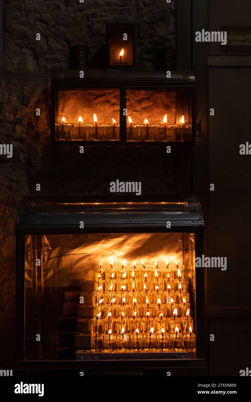 Burning Hanukkah candles cast a glow on the cobblestone streets of the ...